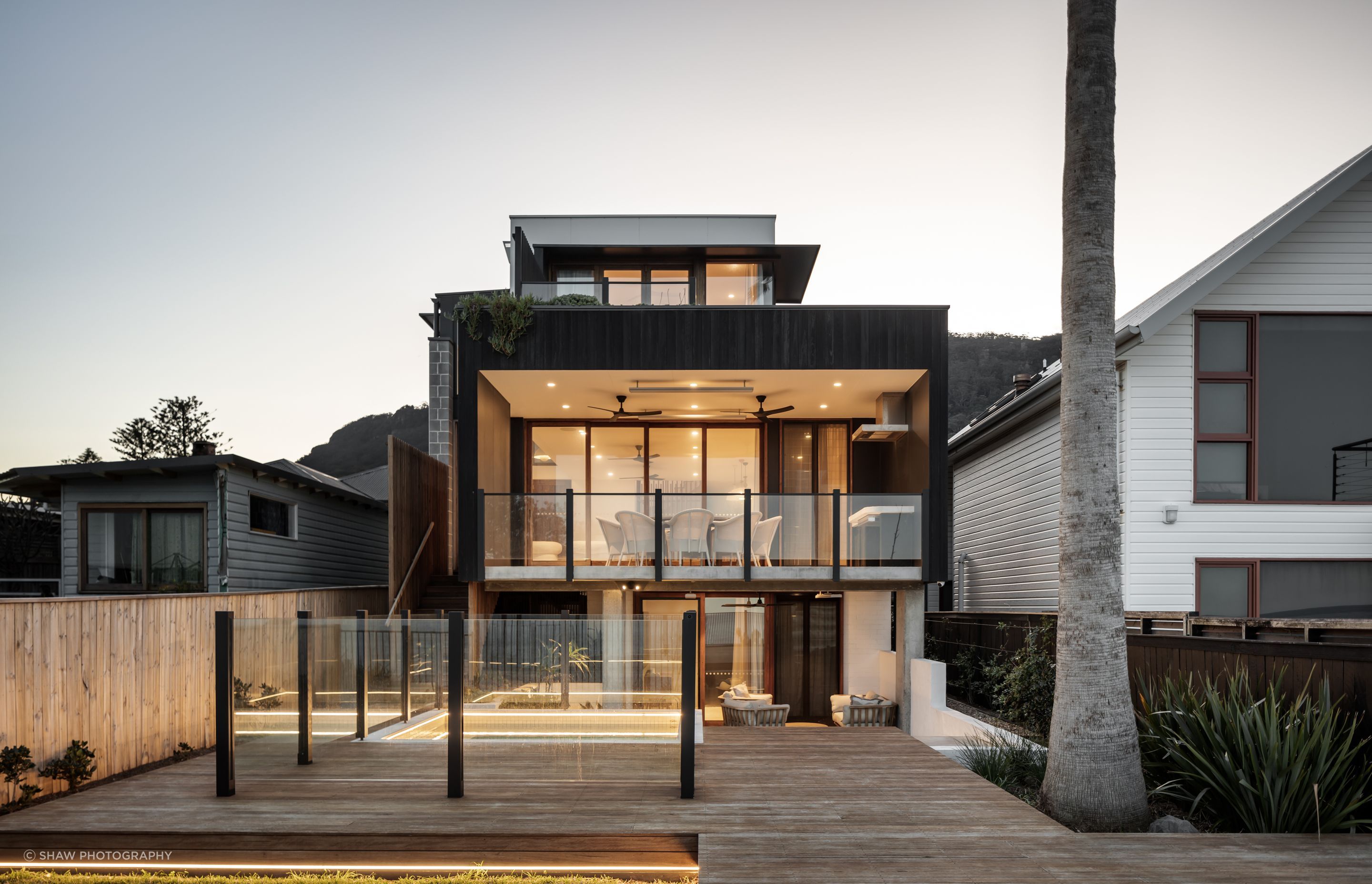 This striking modern home captures sweeping ocean views through an ...