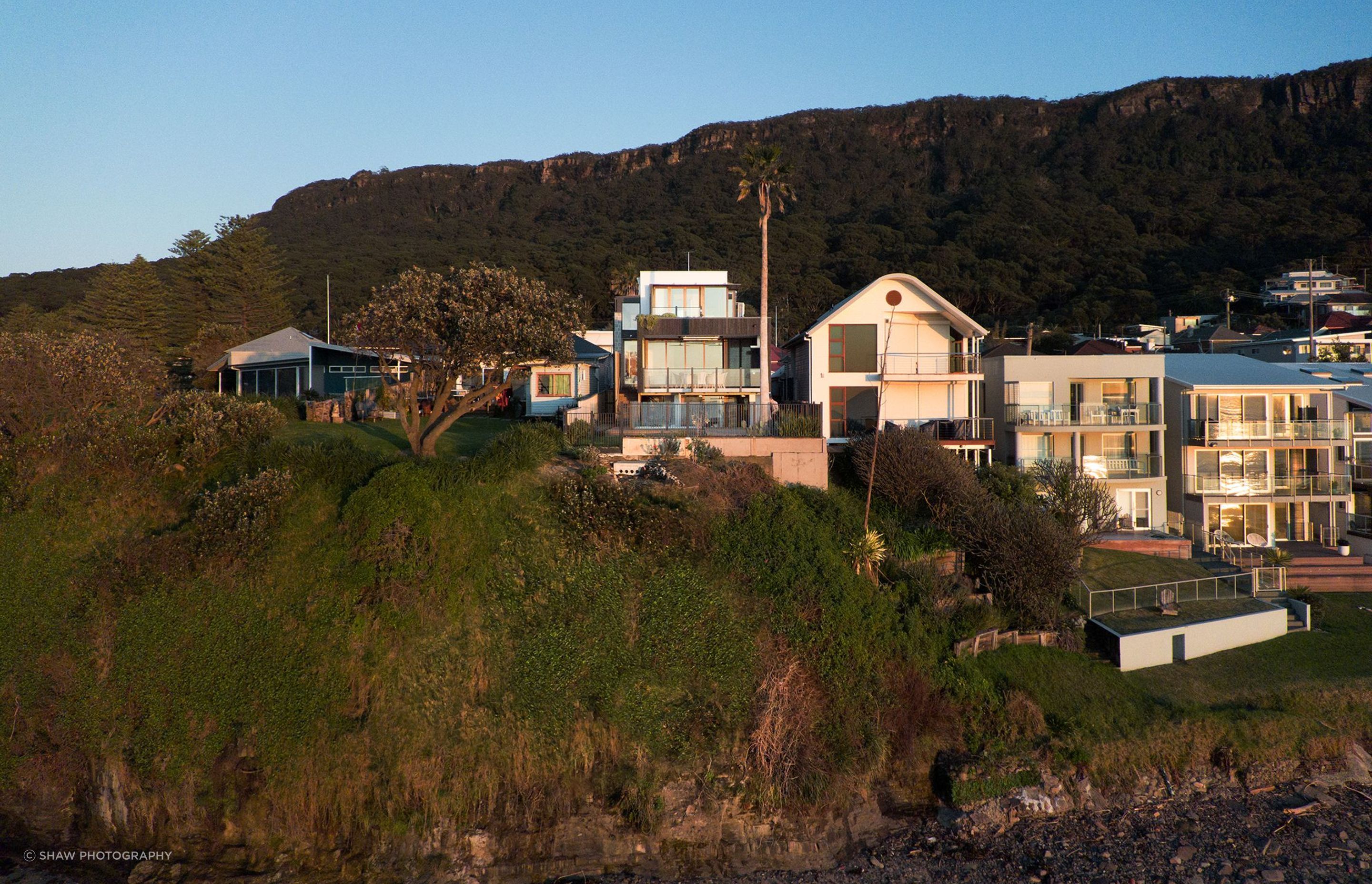 This striking modern home captures sweeping ocean views through an ...