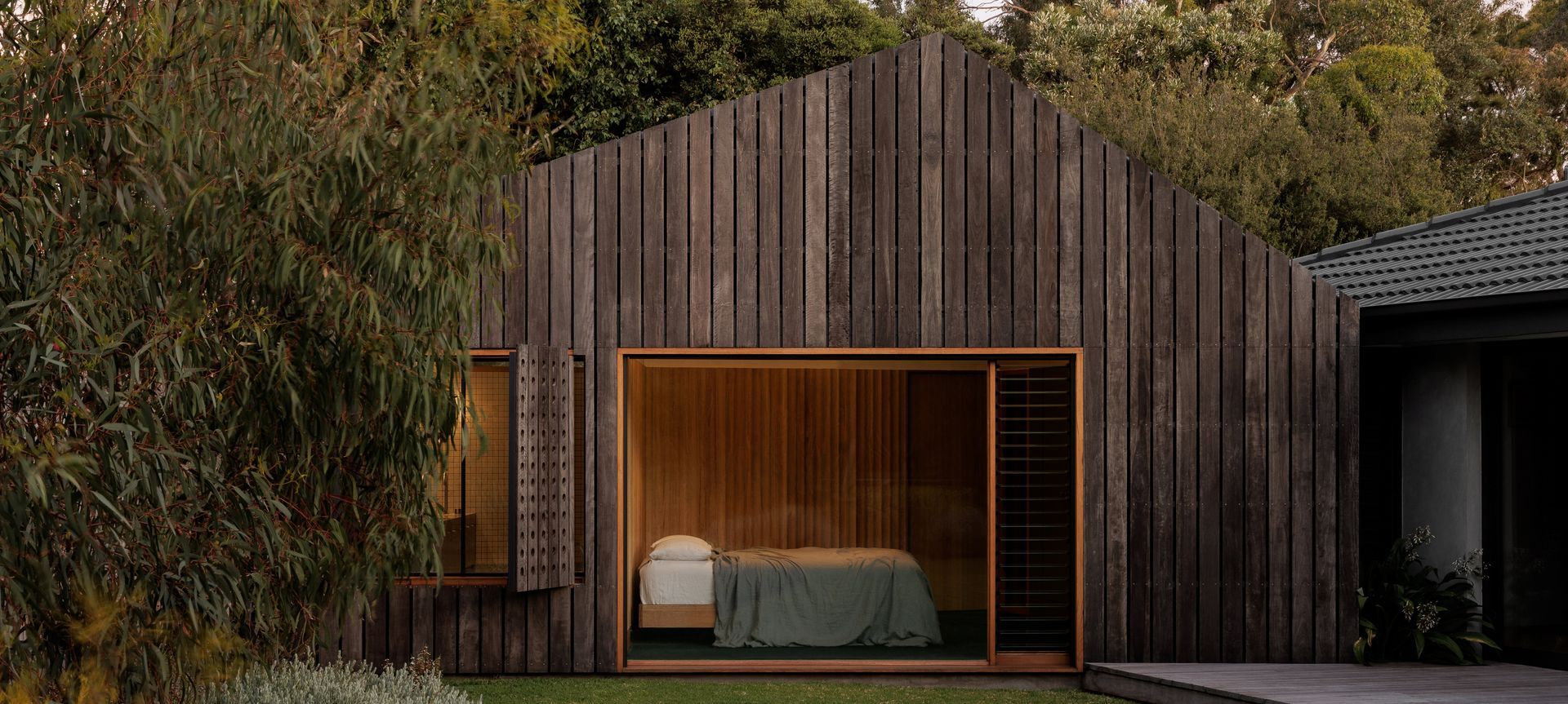 Clad in spotted gum, this rustic addition offers a serene and low ...