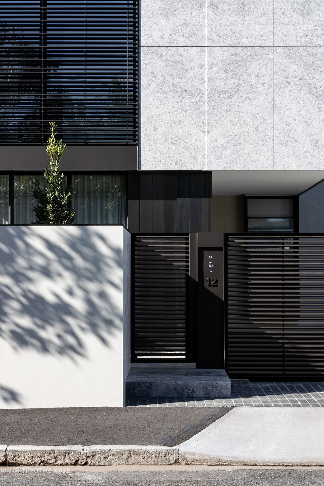 House of Bronzed Steel and Stone by Anderson Construction | ArchiPro AU