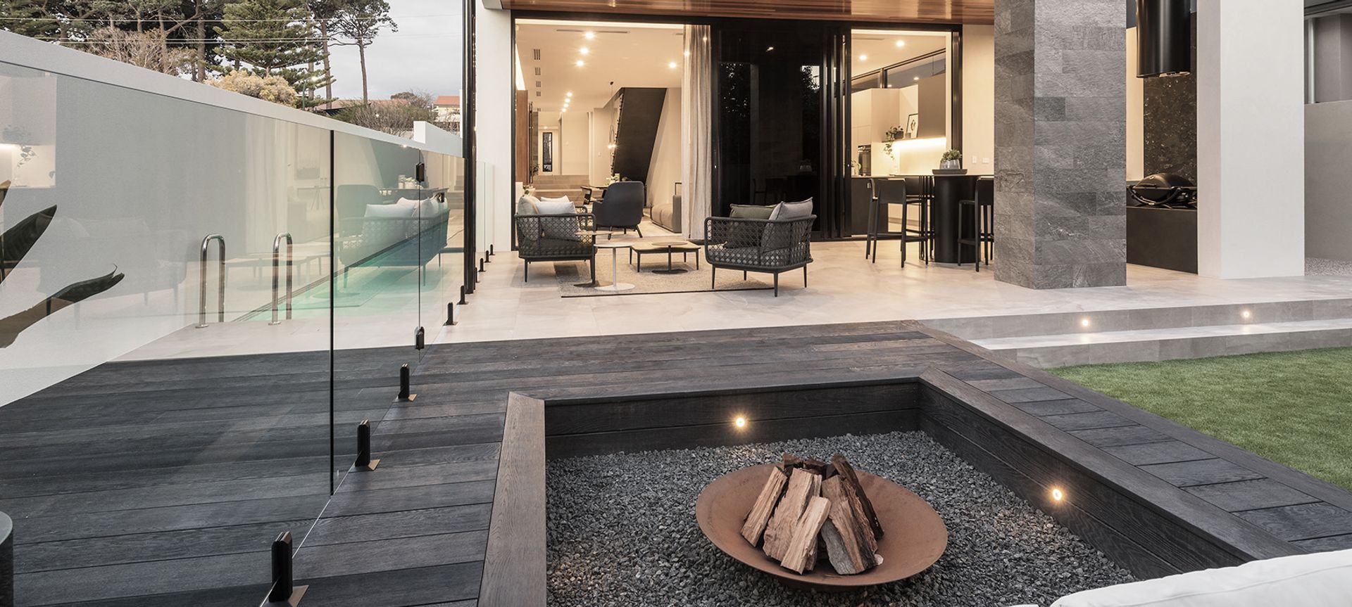 Backyard Fire pit featuring Burnt Cedar with lap pool