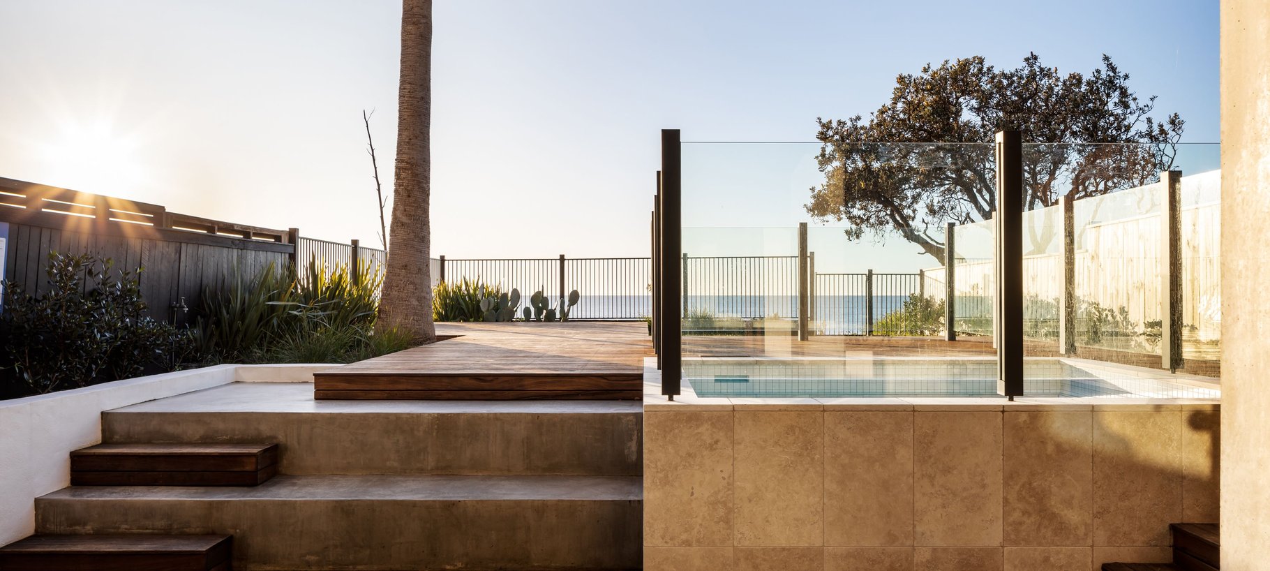 This striking modern home captures sweeping ocean views through an ...
